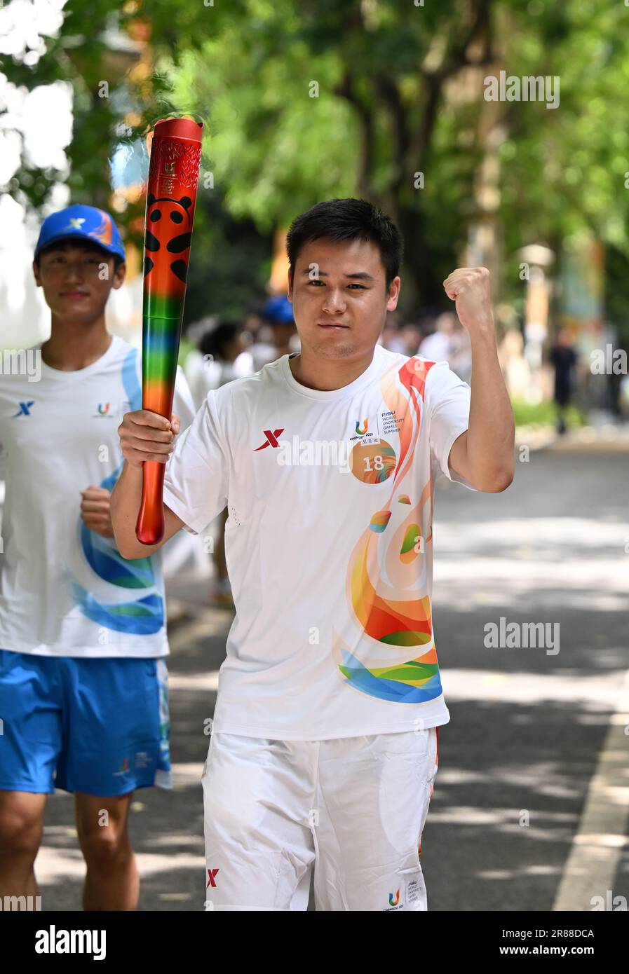Shenzhen. 20th June, 2023. Torch bearer Lai Jiaxin runs with the torch ...