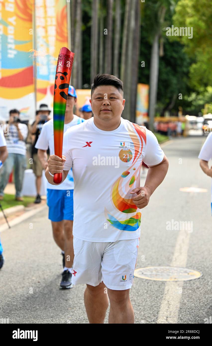 Shenzhen. 20th June, 2023. Torch bearer Liu Jie runs with the torch ...