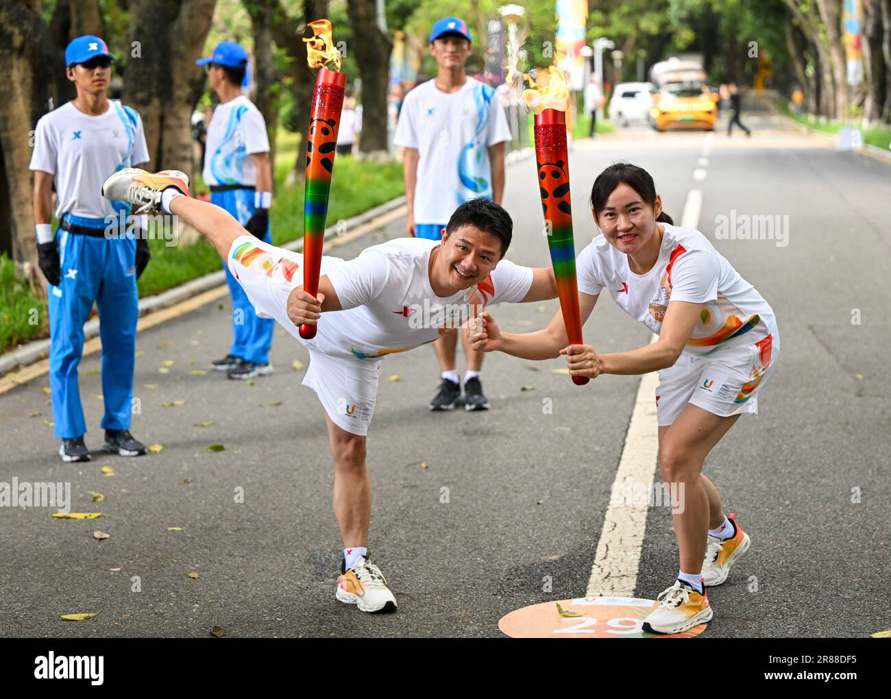 Shenzhen. 20th June, 2023. Torch bearers Zhong Tianshi (R) and Chen ...