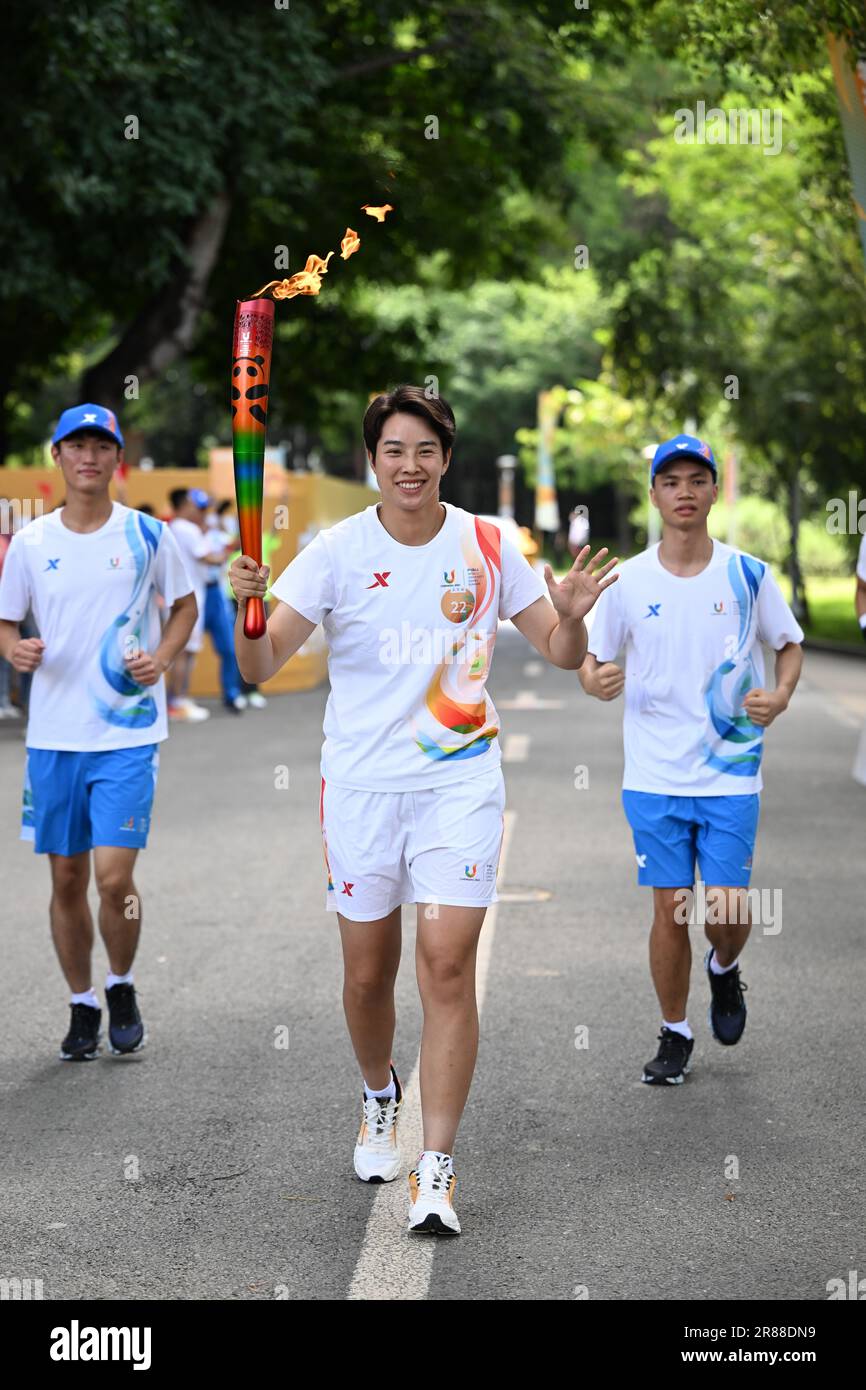 Shenzhen. 20th June, 2023. Torch bearer Yang Yan runs with the torch during the torch relay of ...