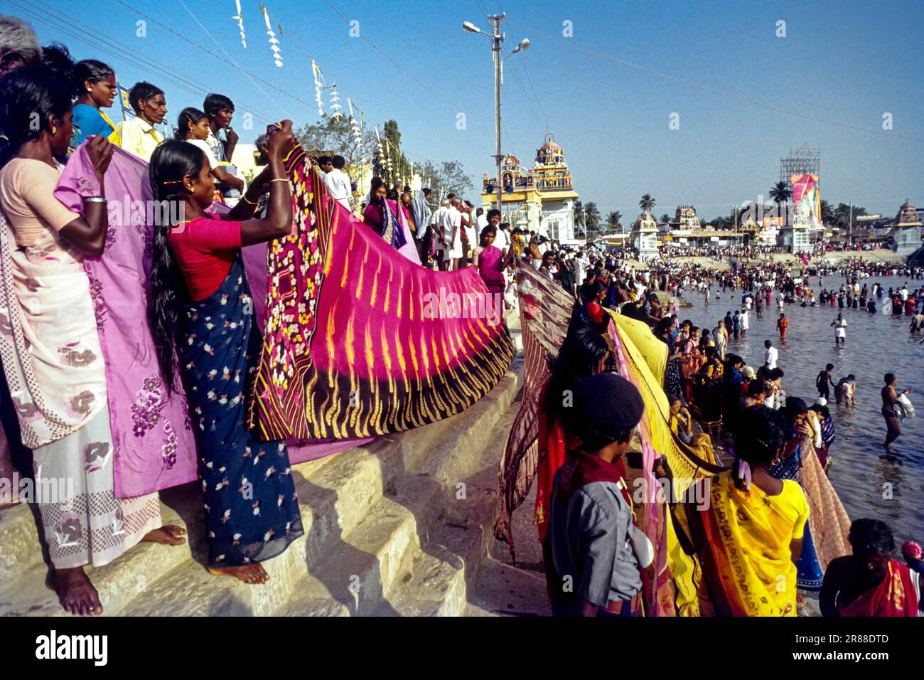 Bathers drying their sarees on the steps of the Mahamakham tank during ...