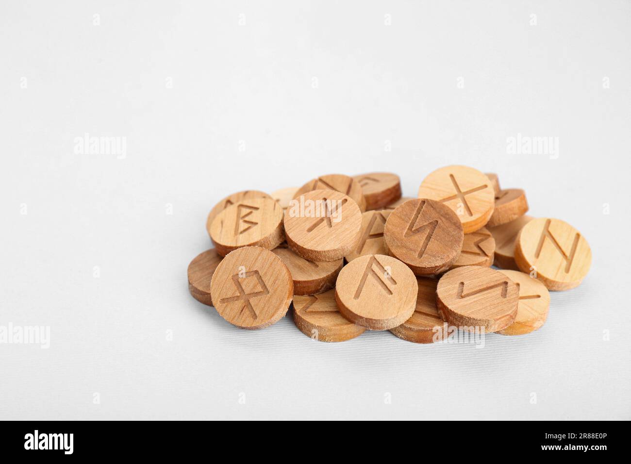 Pile of wooden runes on white background Stock Photo - Alamy