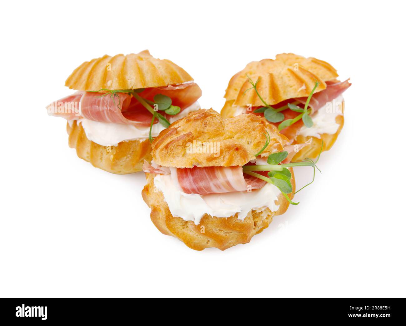 Delicious profiteroles with cream cheese and prosciutto isolated on ...