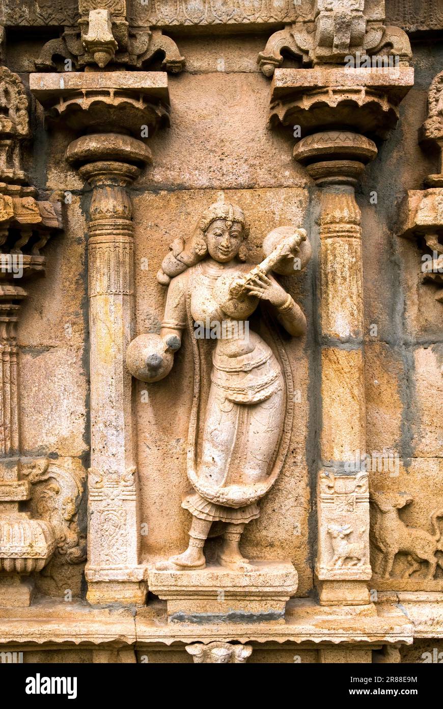 Richly carved statue of beautiful woman with musical instrument on the ...
