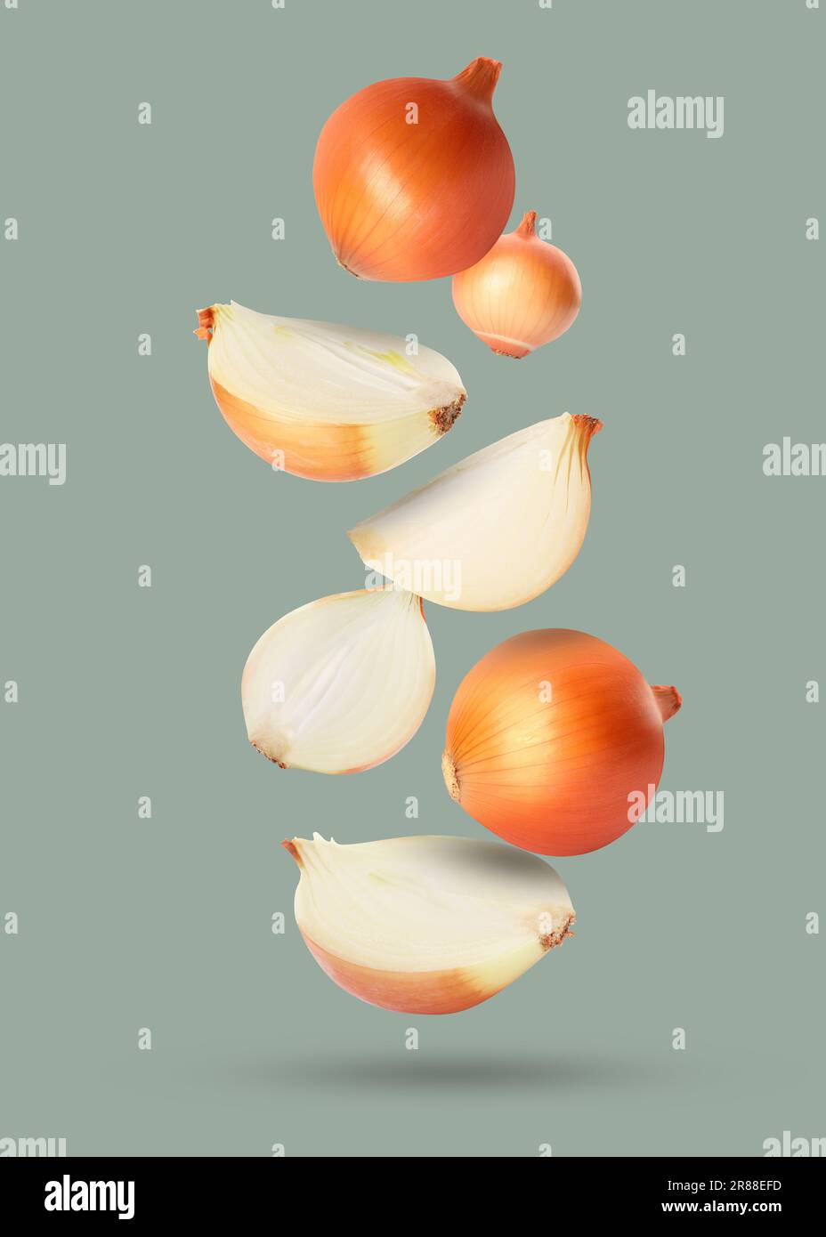 Cut and whole onions falling on light grey background Stock Photo - Alamy