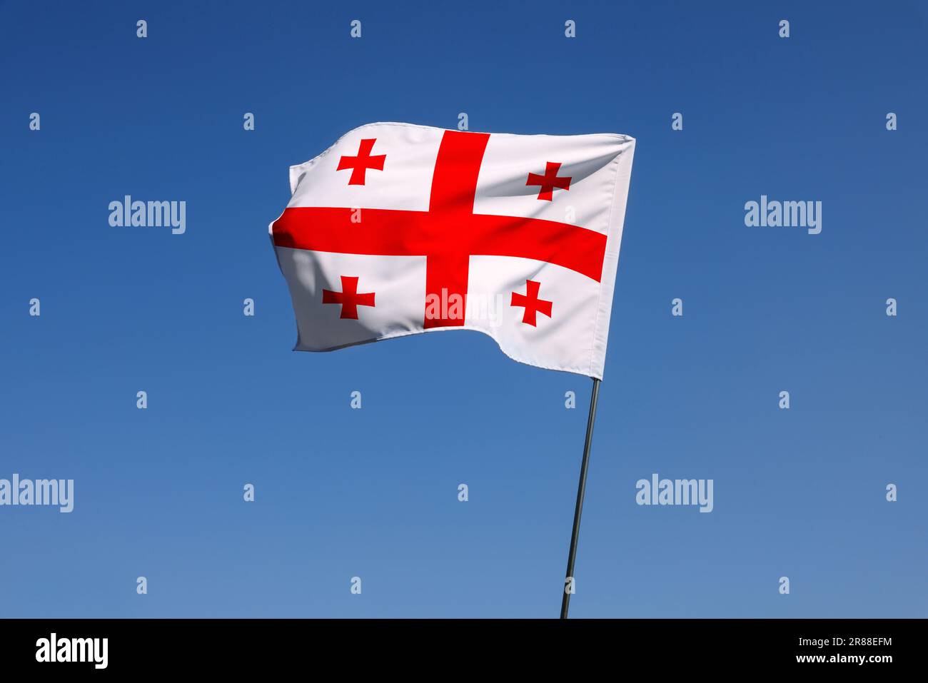 National flag of Georgia against blue sky Stock Photo - Alamy