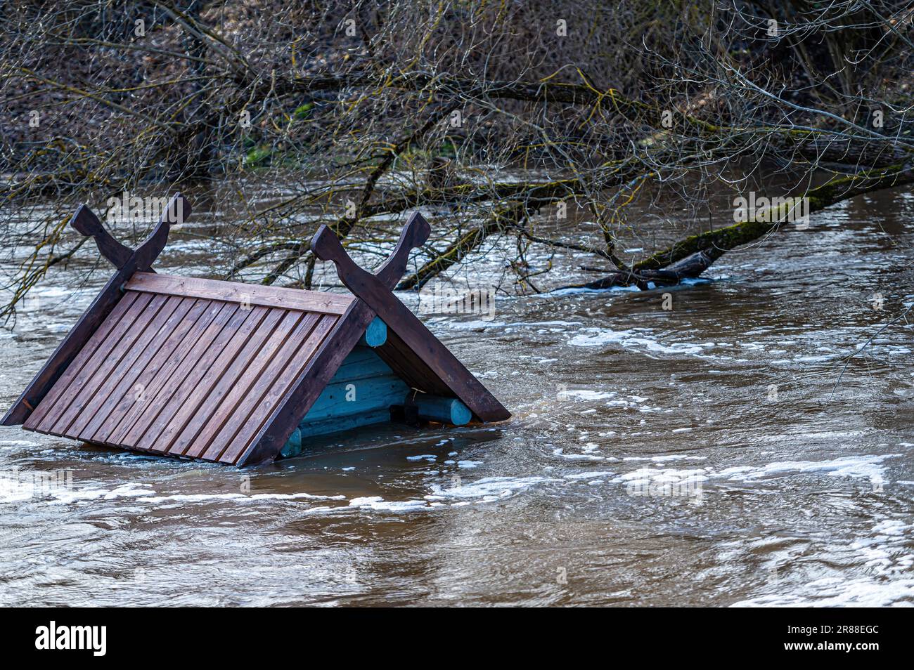 to the roof of a bird house flooded in spring floods - a feeder on the ...