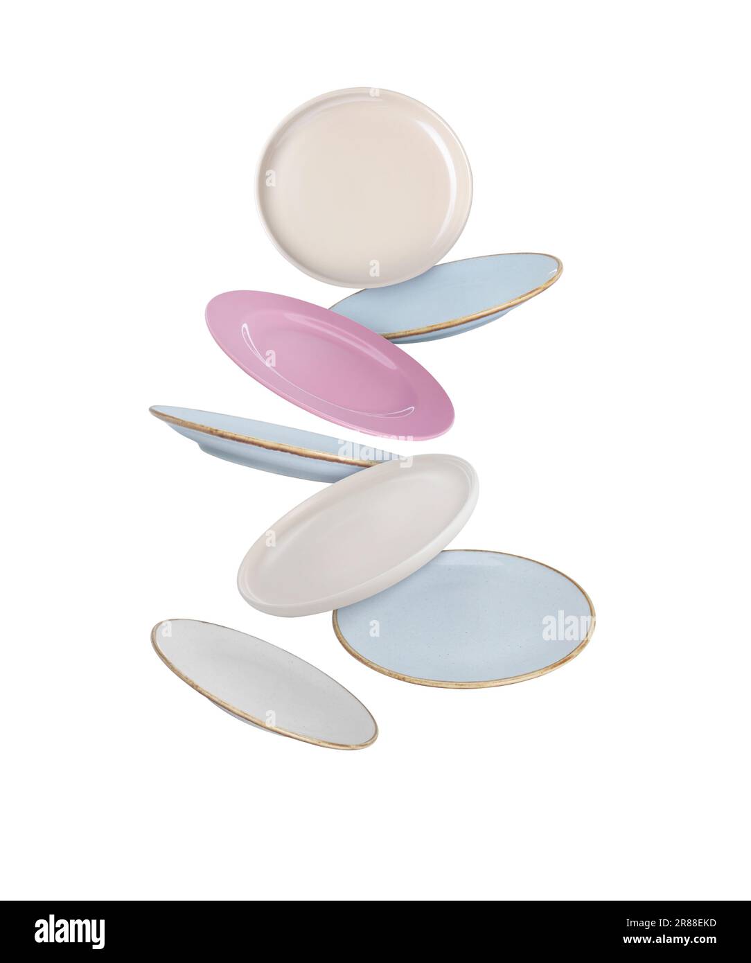Many different plates falling on white background Stock Photo - Alamy