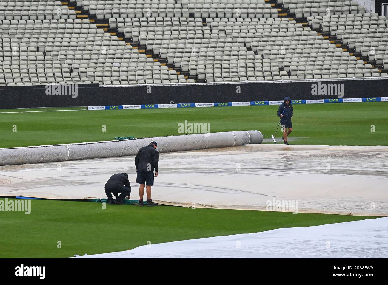 A general view of Edgbaston as heavy rain falls and ground staff try to ...