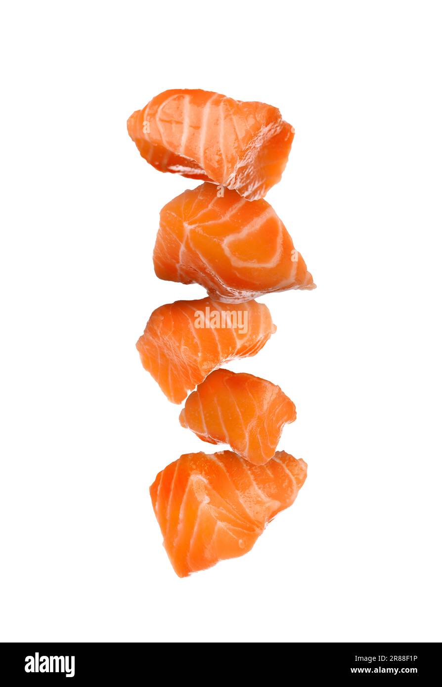 Cut fresh salmon falling on white background Stock Photo - Alamy