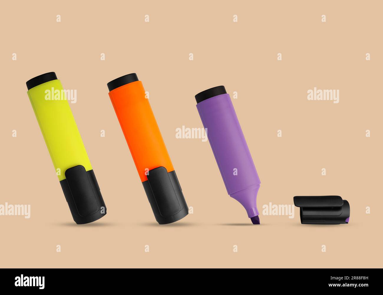 Violet, orange and yellow markers on beige background Stock Photo - Alamy