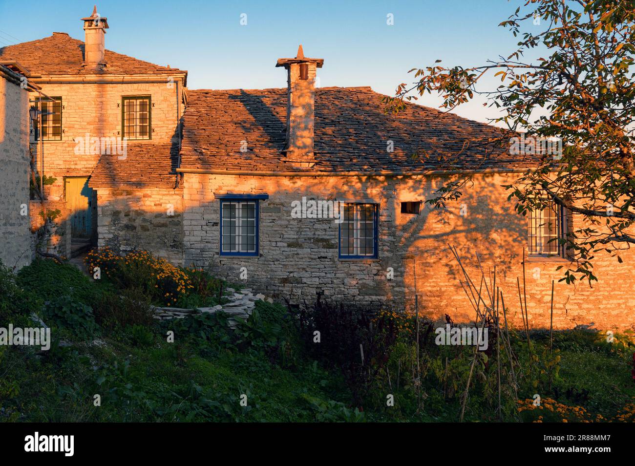Stone houses of traditional architecture in Vitsa, Greece at sunset ...