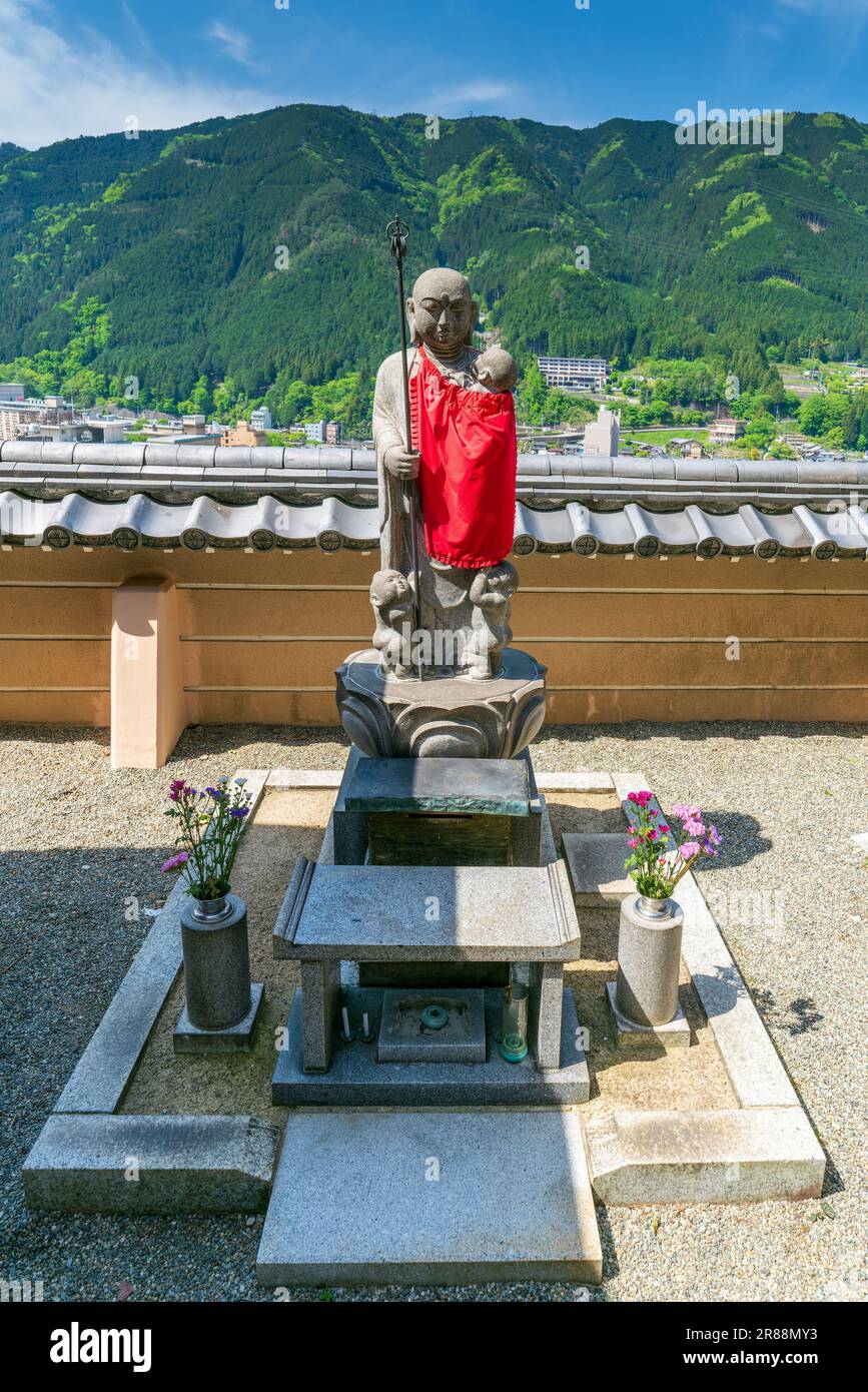 Shrine Statue with red cloth draped around in the Onsenji Buddhist ...