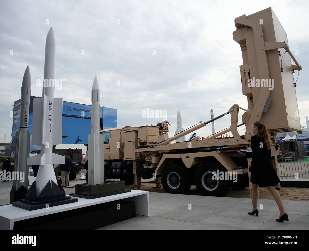 A woman walks past VL MICA NG air defence system presented at the Paris ...