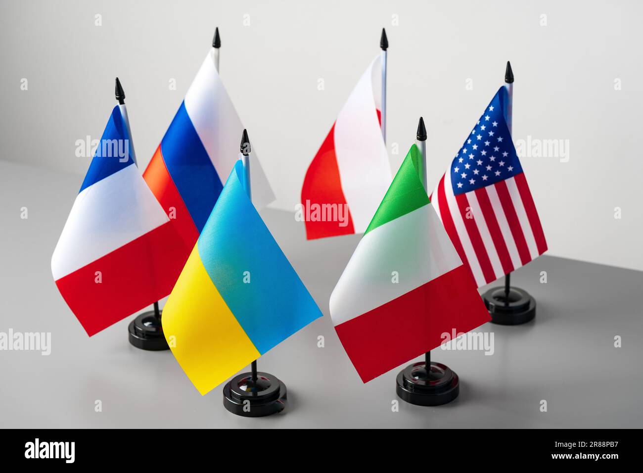 Small country flags standing at a table Stock Photo - Alamy