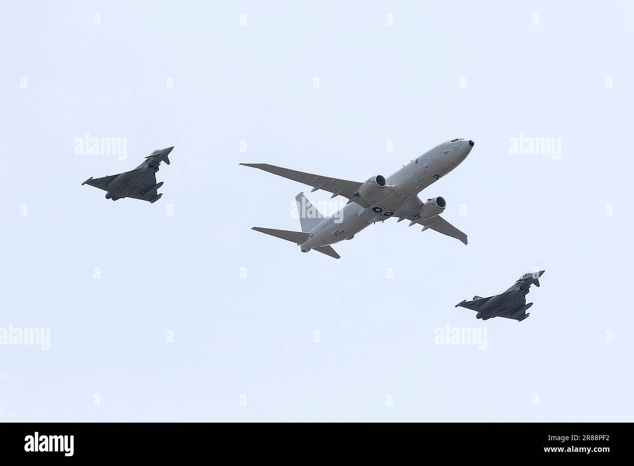 Two Eurofighter Typhoon aircraft flying in formation with a Poseidon ...