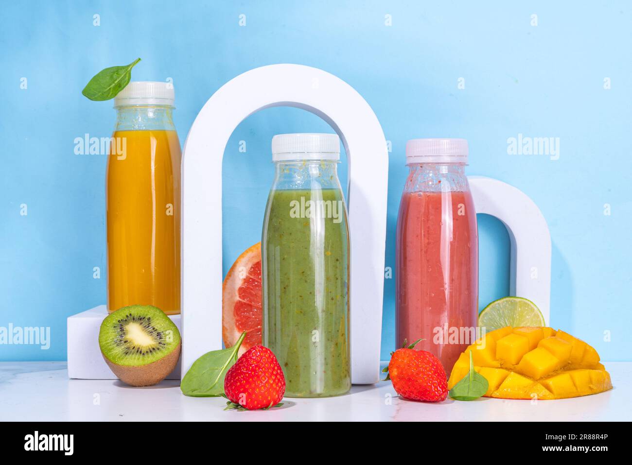 Green, orange and red smoothie in portion bottles, Mix of colourful ...