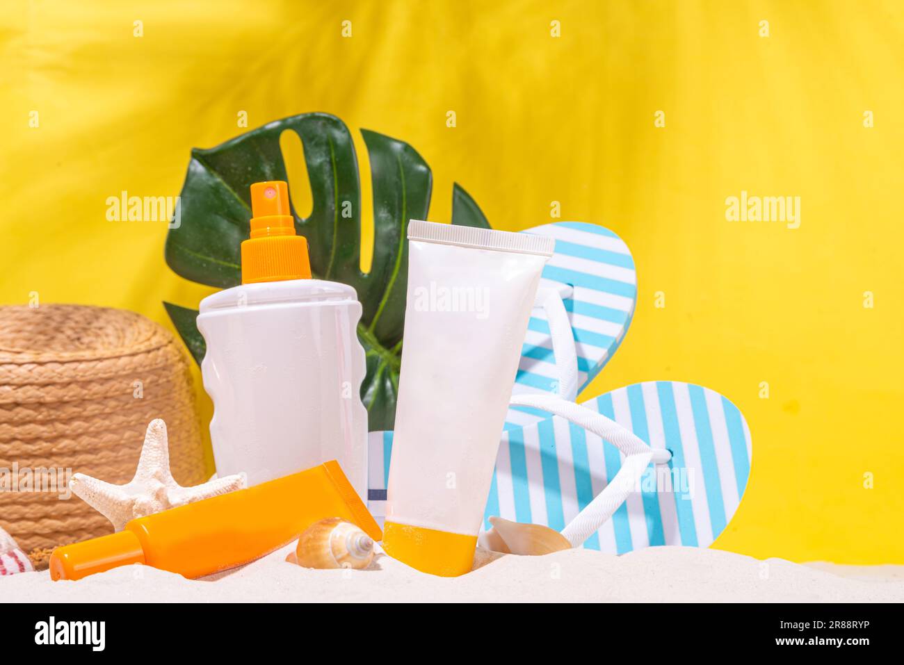 Sunscreen bottles on sand sea beach, electric yellow background. High ...