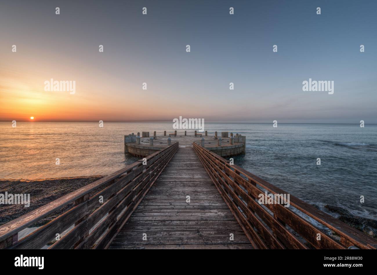 Morning on the pier and the roundabout overlooking the sea with the ...