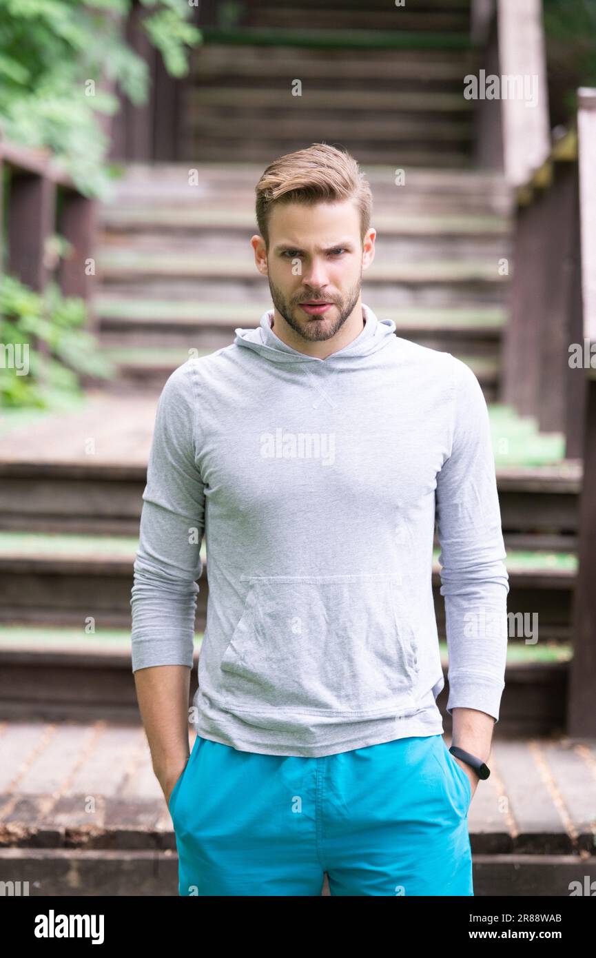 sport man. young fitness sportsman man in hoodie outdoor in the street ...