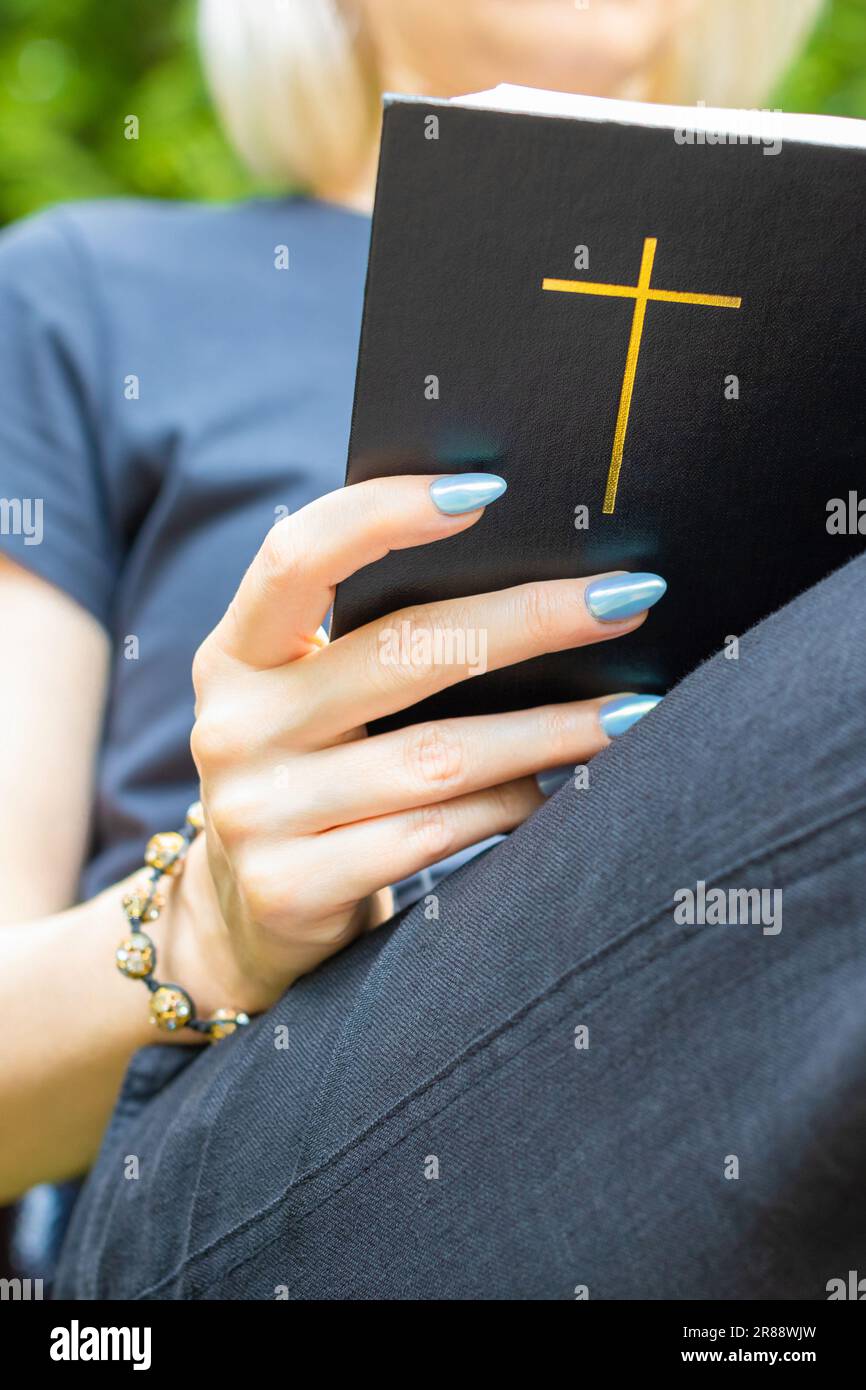 woman reading the bible sitting on a bench. woman reading the bible on ...