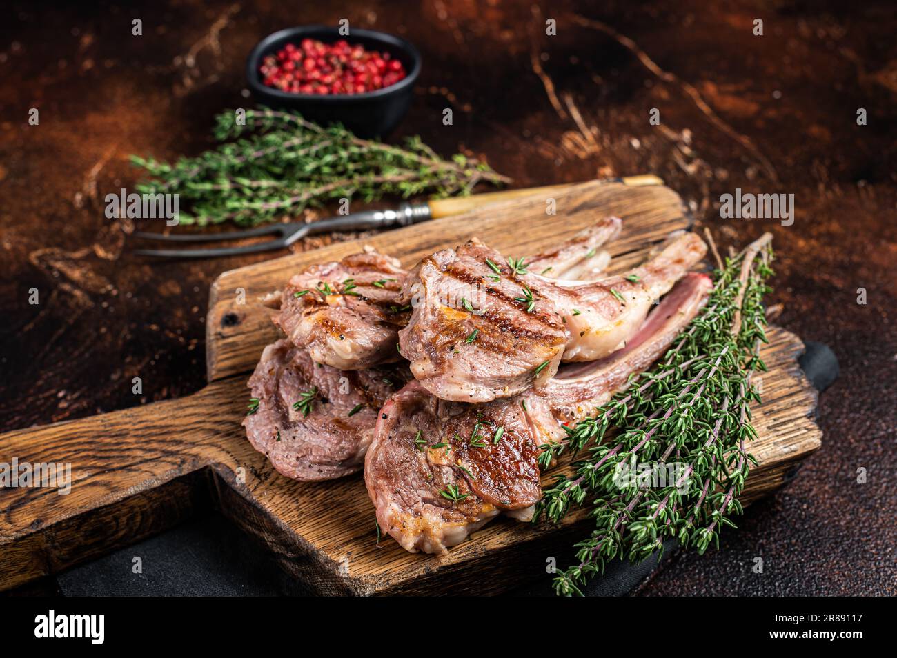 Grilled New Zealand Lamb Chops, mutton cutlets on wooden board. Dark ...