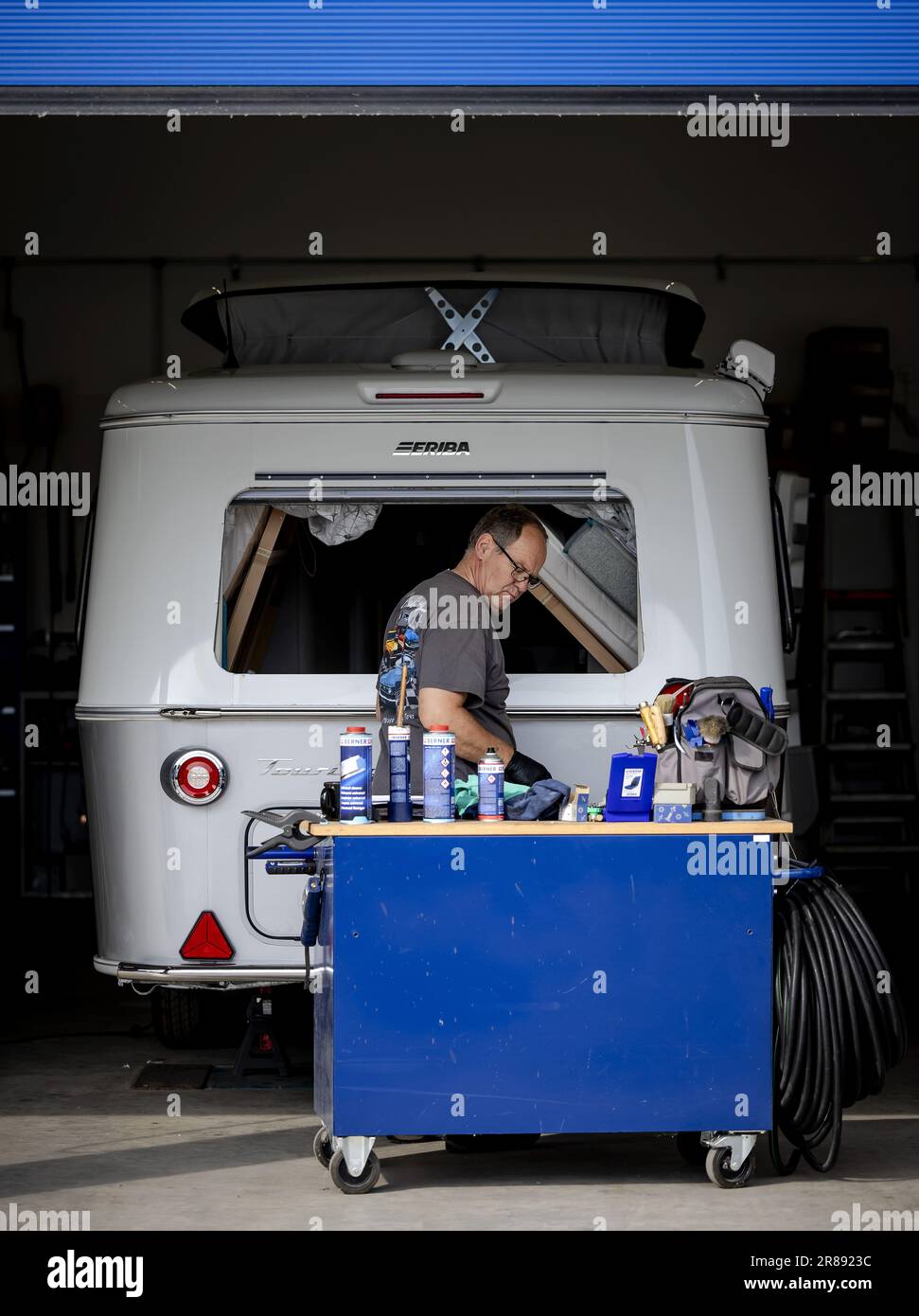ALMERE - An employee of a caravan company carries out an inspection of ...