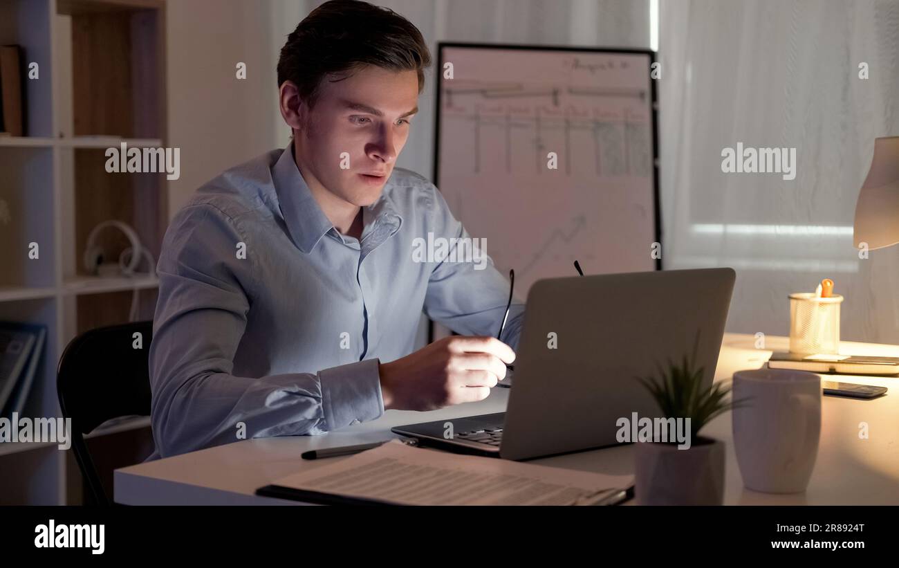 Late work shocked man computer technology laptop Stock Photo - Alamy