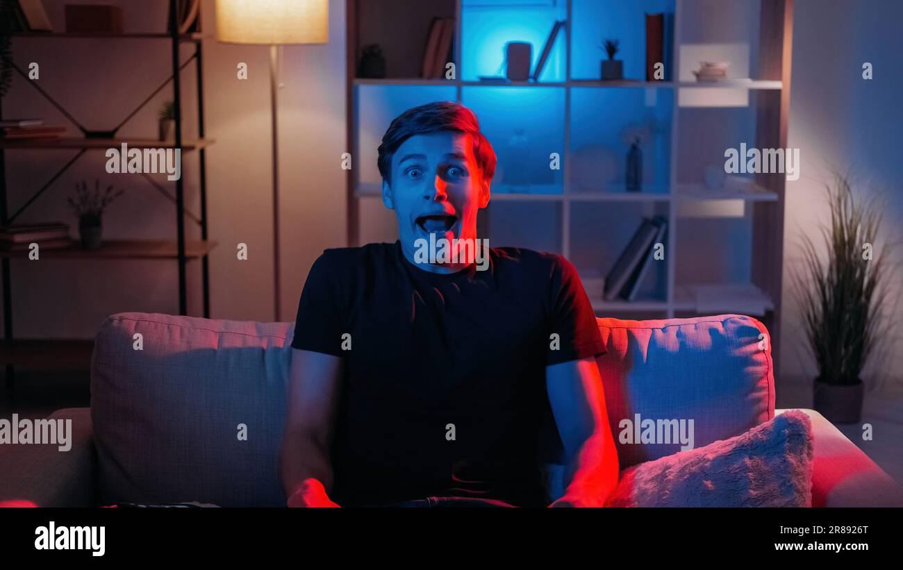 Grimacing man facial expression silly behavior Stock Photo - Alamy