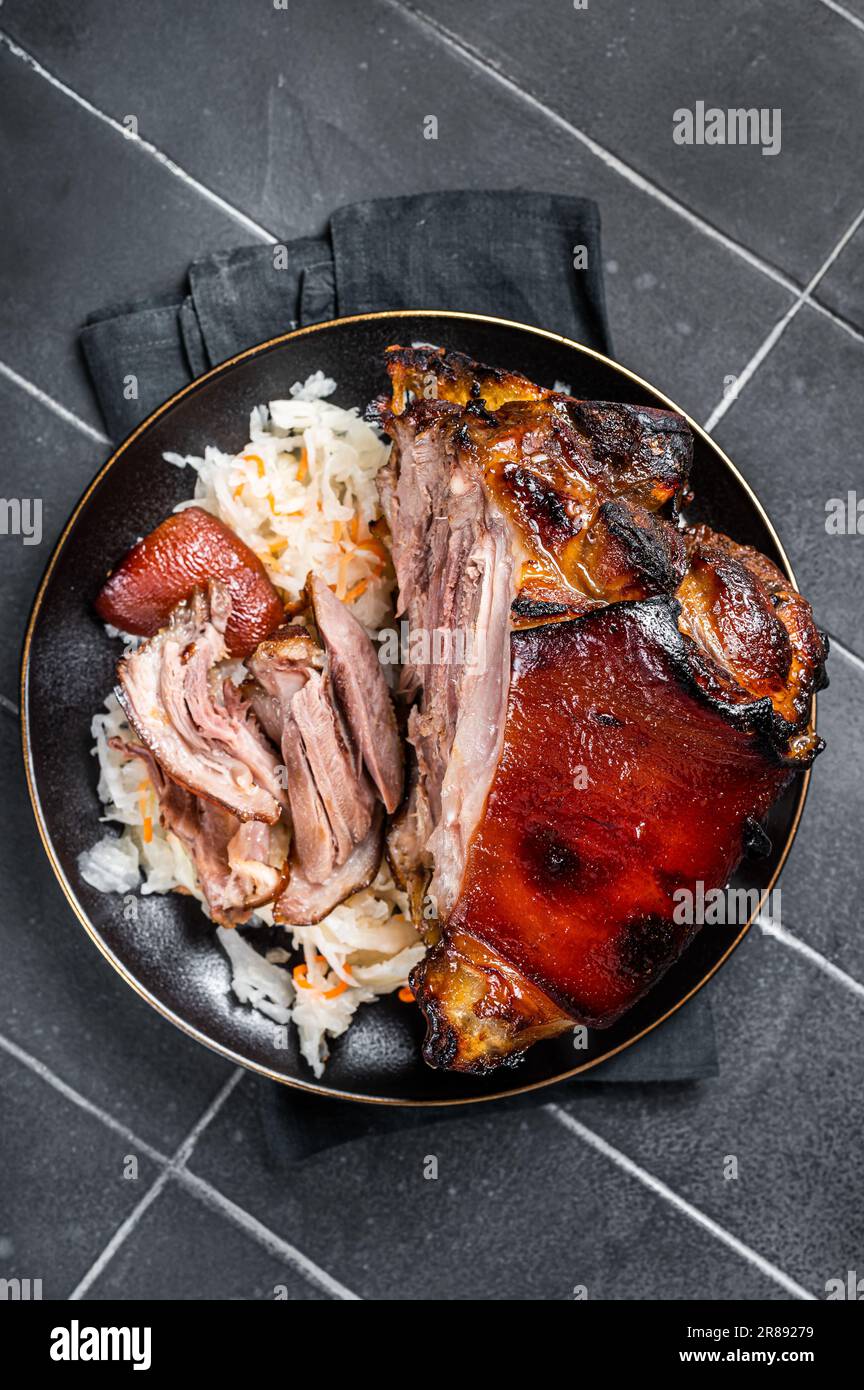 Roast Pork Ham Hock, knuckle with Sauerkraut on a plate. Black ...