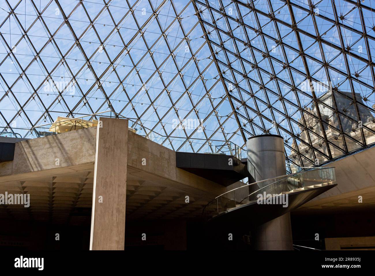 A diverse group of people standing outside of the iconic glass pyramid ...
