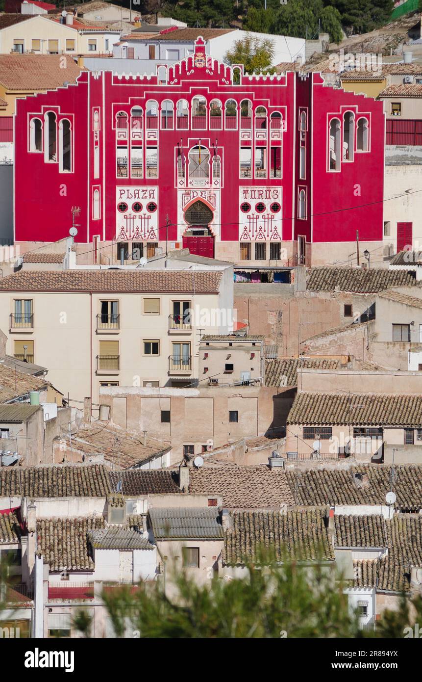 An iconic red and white building with a clock tower stands atop a hill ...