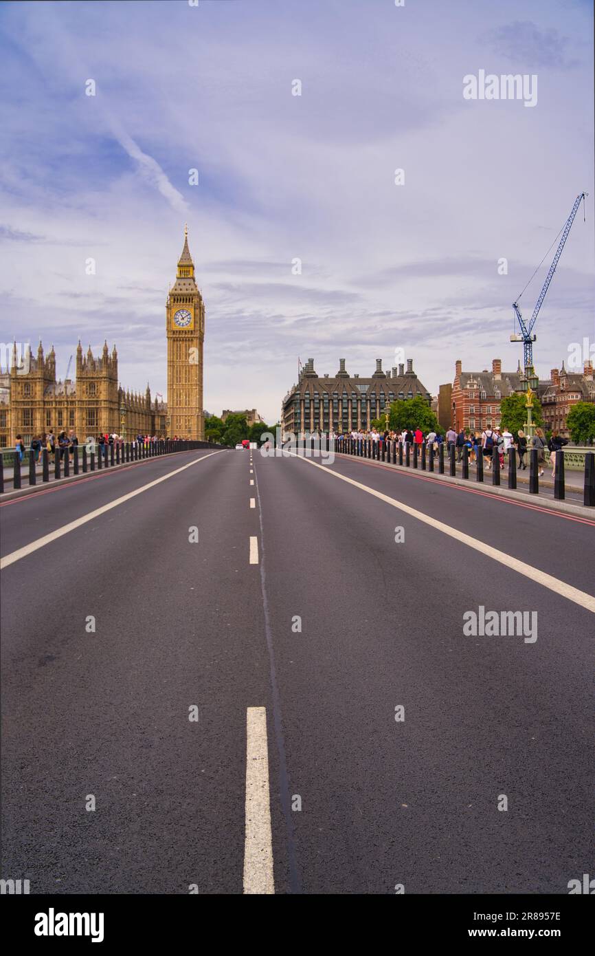 A busy street in a city with multiple cars parked along the curb ...