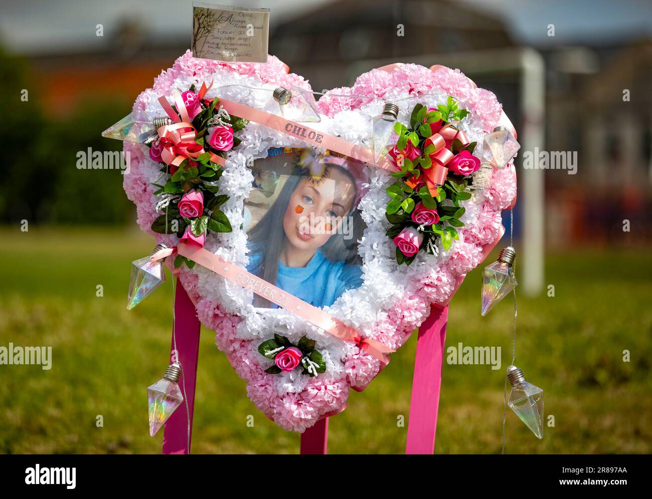 A picture of Chloe Mitchell sits within a floral tribute at King George ...