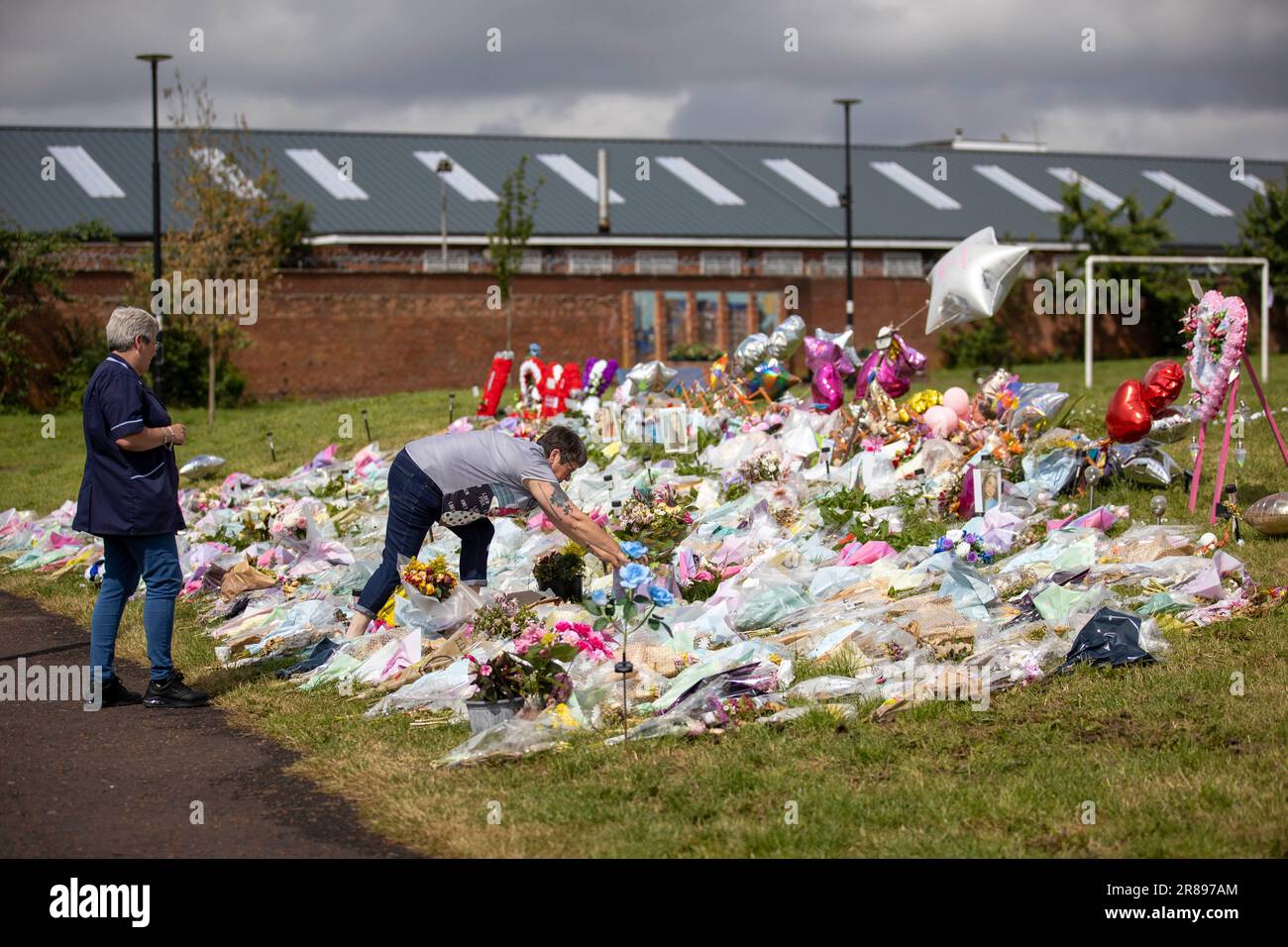 A woman leaves a floral tribute at King George's Park in Harryville ...