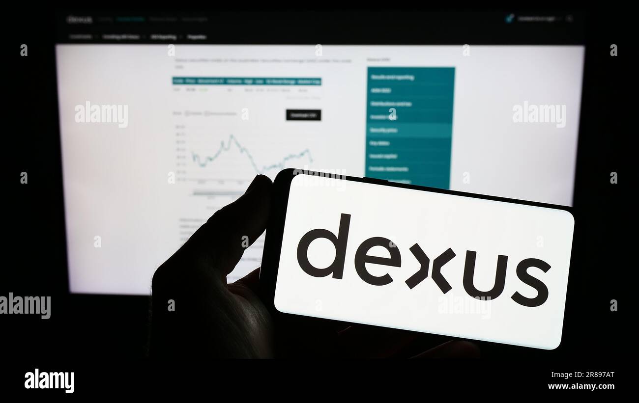 Person holding mobile phone with logo of Australian real estate company ...