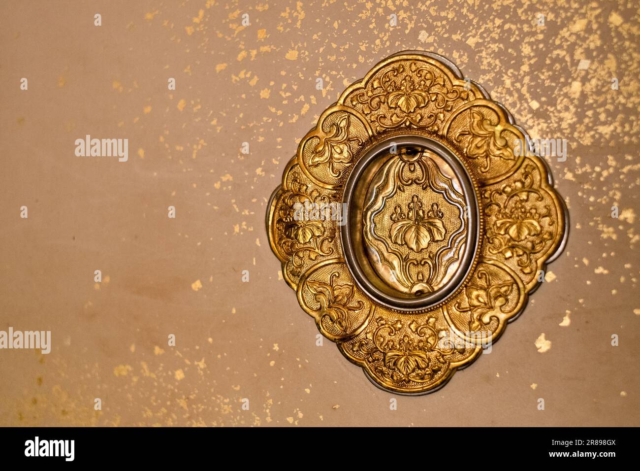 Detail of an ornate golden door handle in a room in Mitsugonin Temple ...