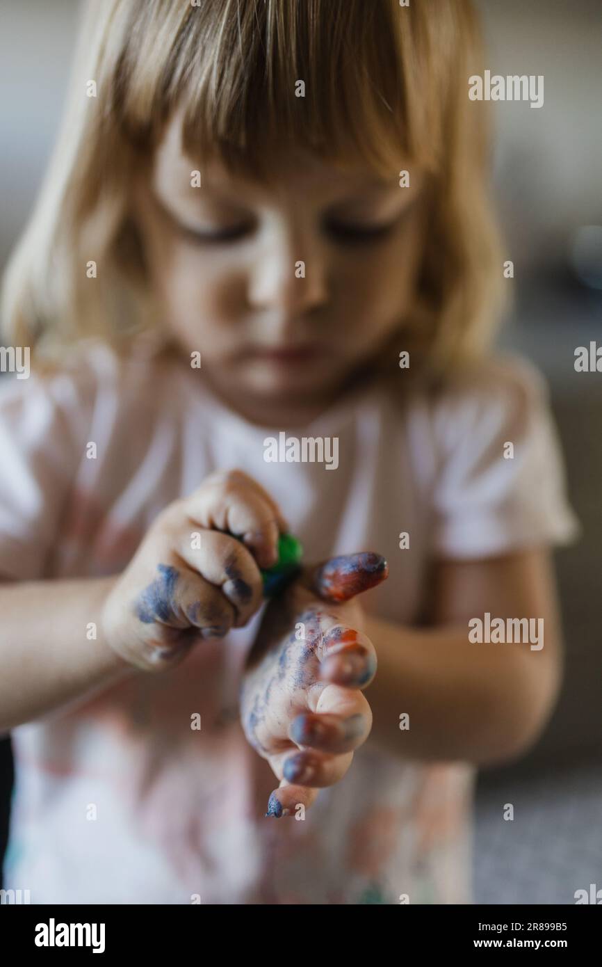 Portrait of little girl with messy hands stained with paint Stock Photo ...