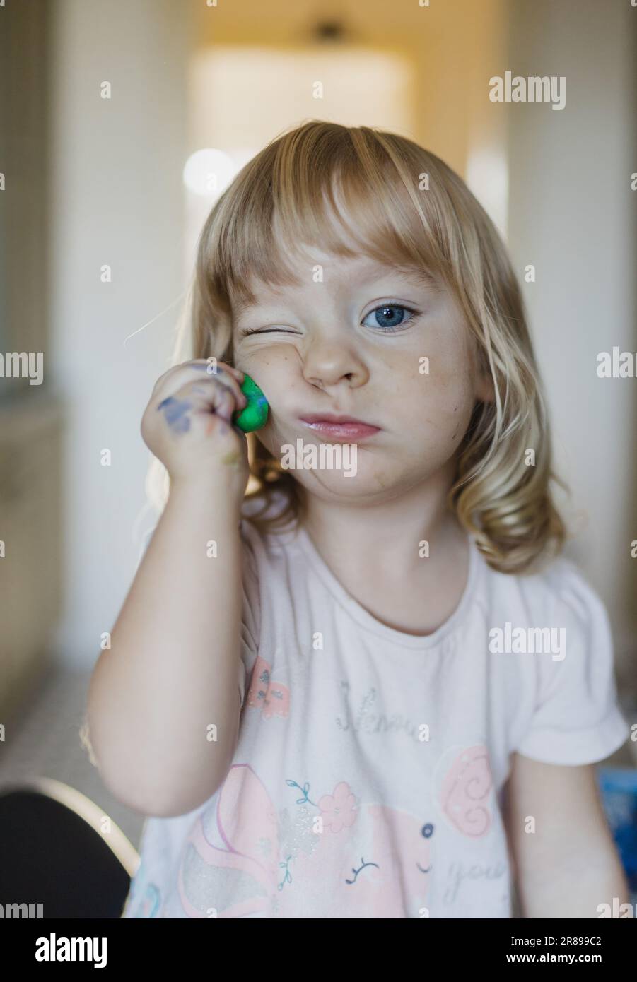 Portrait of cute little girl playing with playdough Stock Photo - Alamy