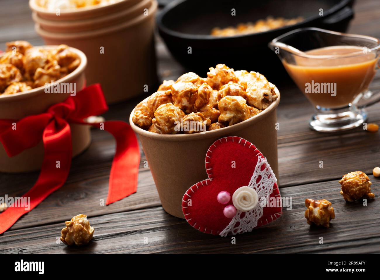 Carton buckets with caramelized popcorn and valentine decorations on ...