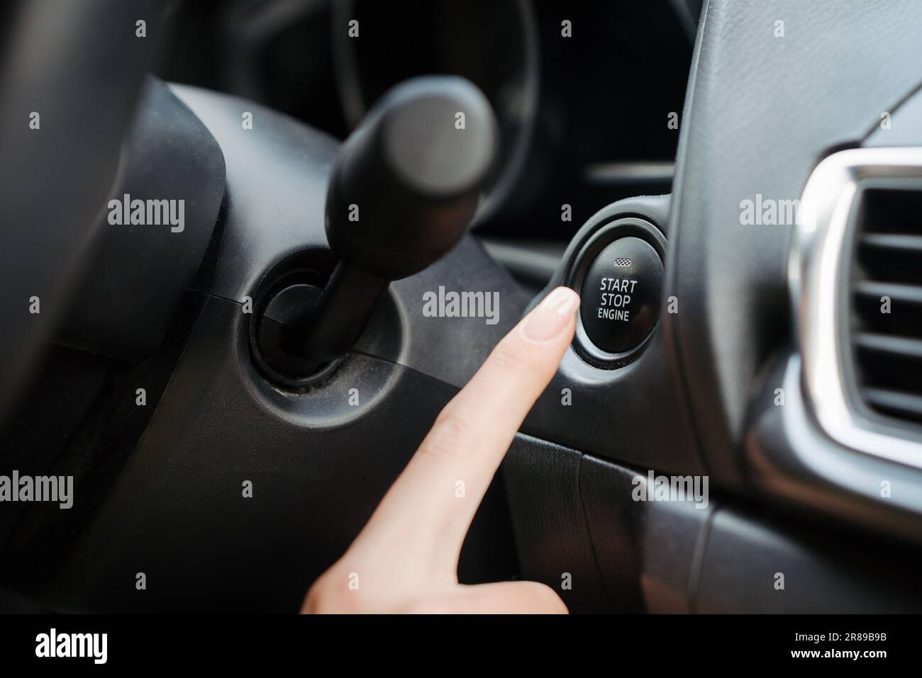 Close up of finger pressing engine start button until engine turns on ...