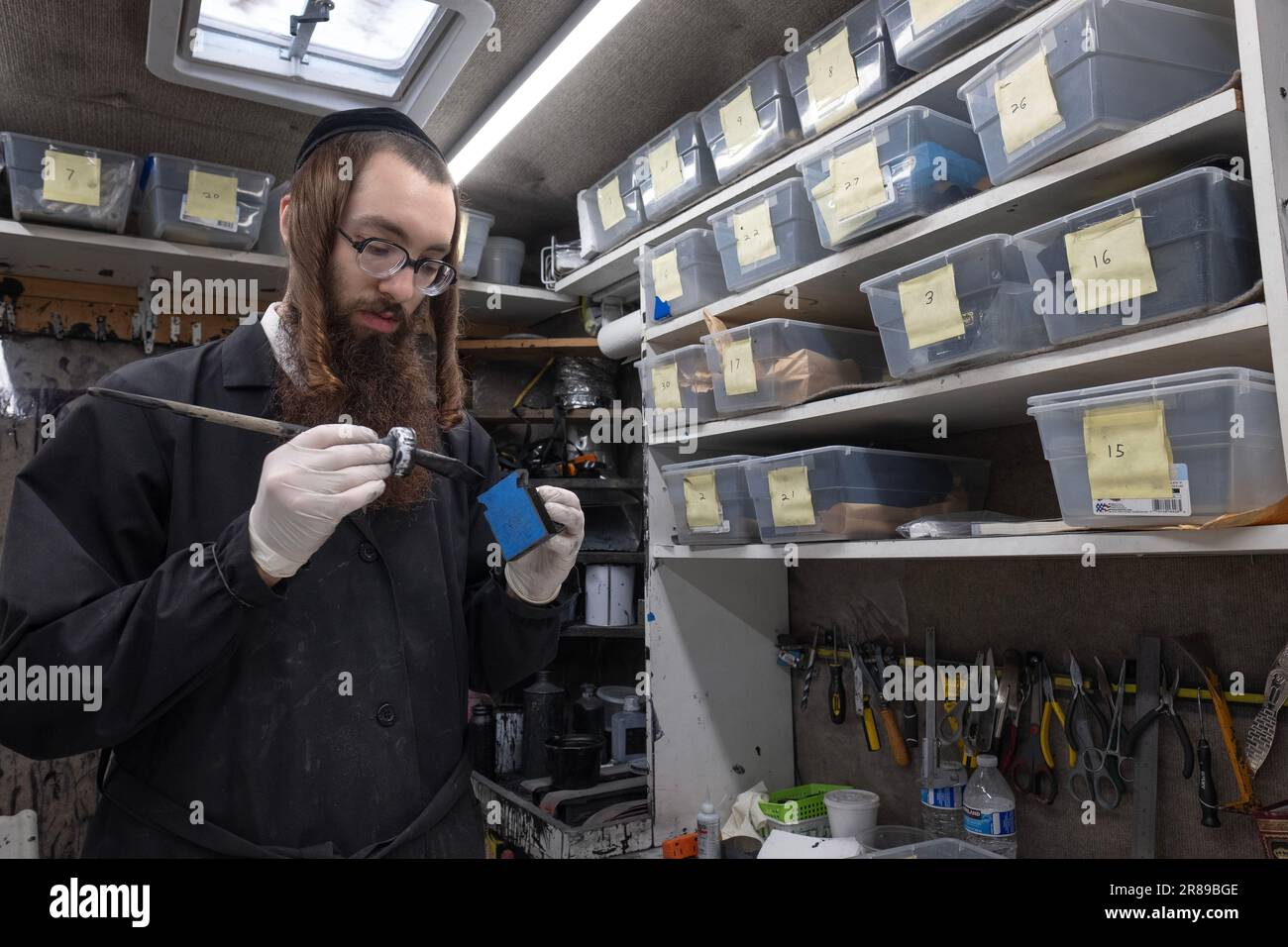 An orthodox Jewish craftsman refurbishes tefillin boxes which are used ...