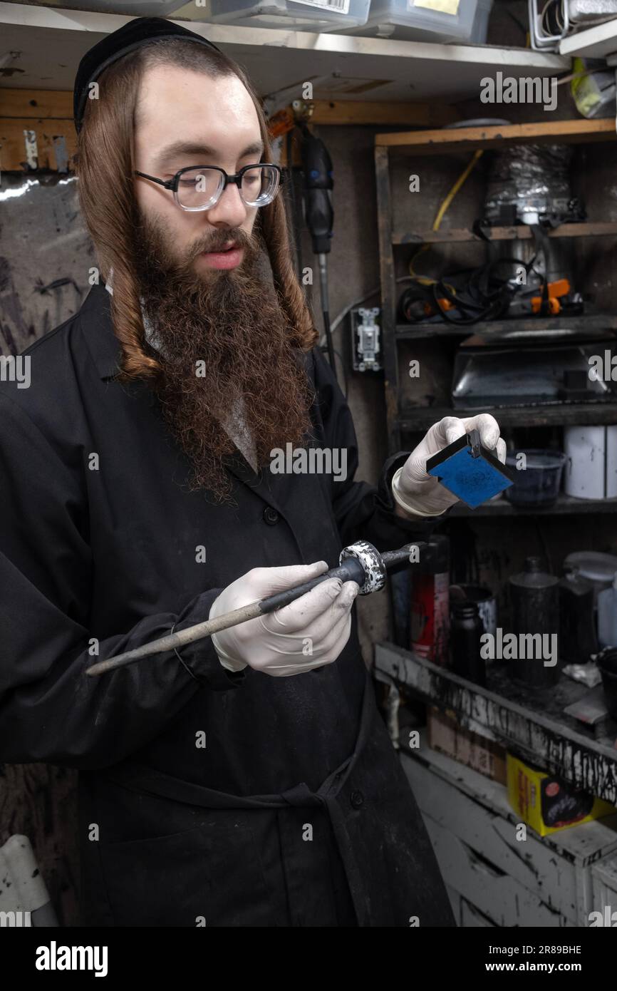 An orthodox Jewish craftsman refurbishes tefillin boxes which are used ...