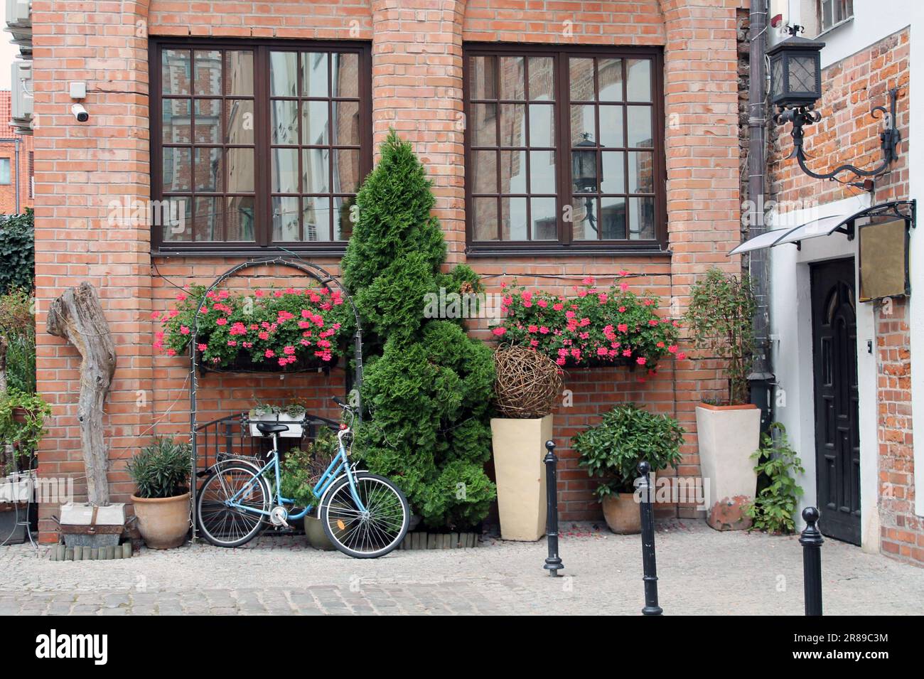 The backyard of an old red brick house in the Polish city of Gdansk ...