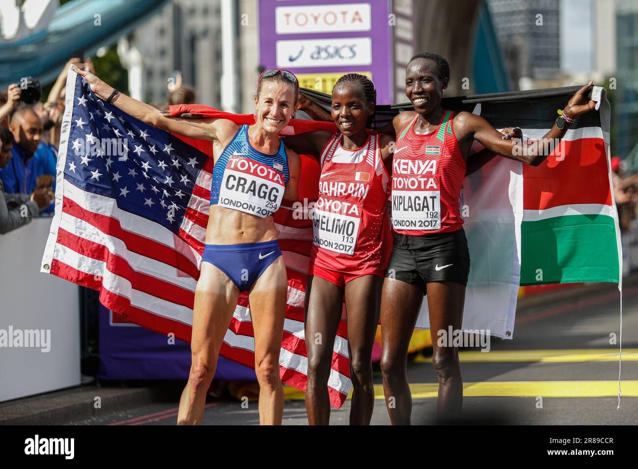 Rose Chelimo,Edna Ngeringwony Kiplagat,Amy Cragg winning with the flag ...