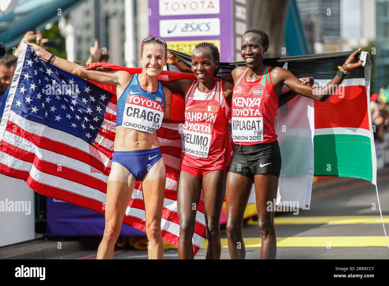 Rose Chelimo,Edna Ngeringwony Kiplagat,Amy Cragg winning with the flag ...