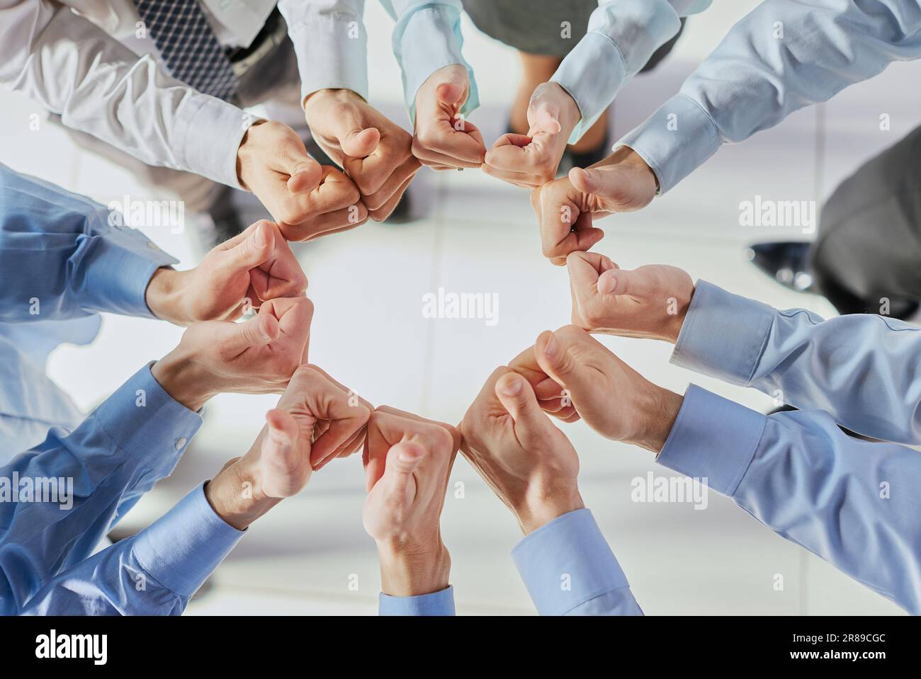 Business people, fist circle and teamwork in low angle, team building ...