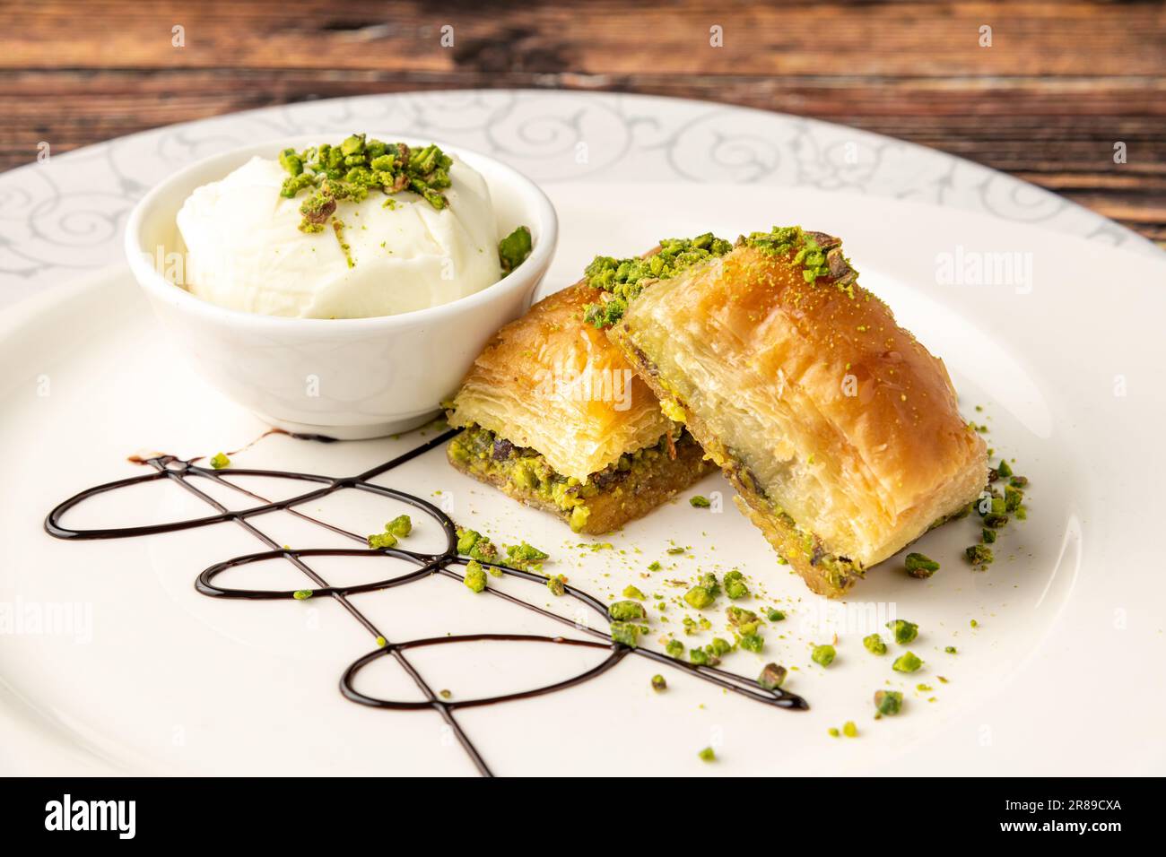 Traditional Turkish dessert pistachio baklava on a white porcelain ...