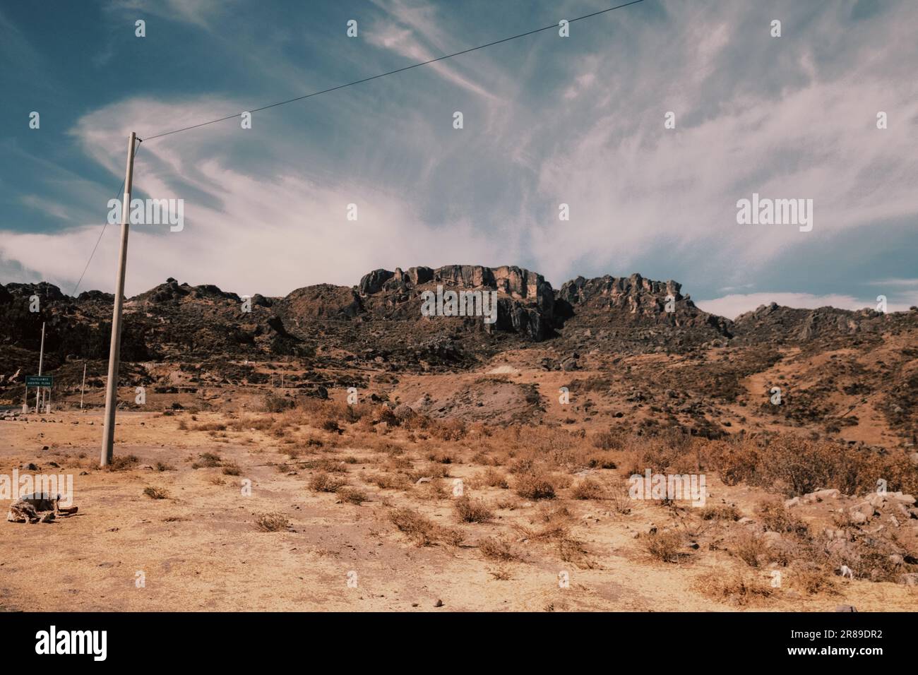 An arid, desert-like environment featuring power lines and telephone ...