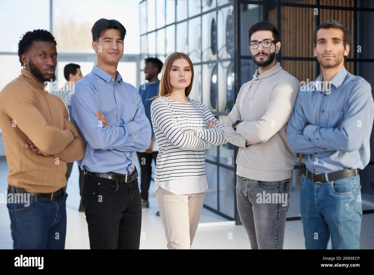 Multiracial business team standing in the office Stock Photo - Alamy